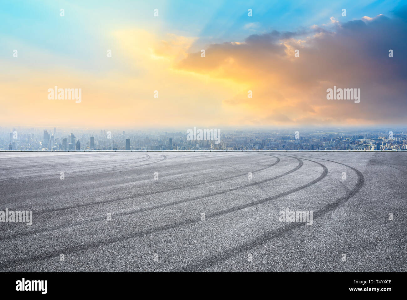 Shanghai city skyline and asphalt race track ground scenery at sunrise ...