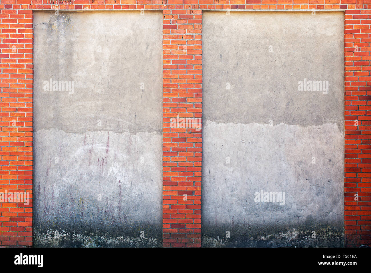 weathered stucco wall and red brick frame around Stock Photo - Alamy