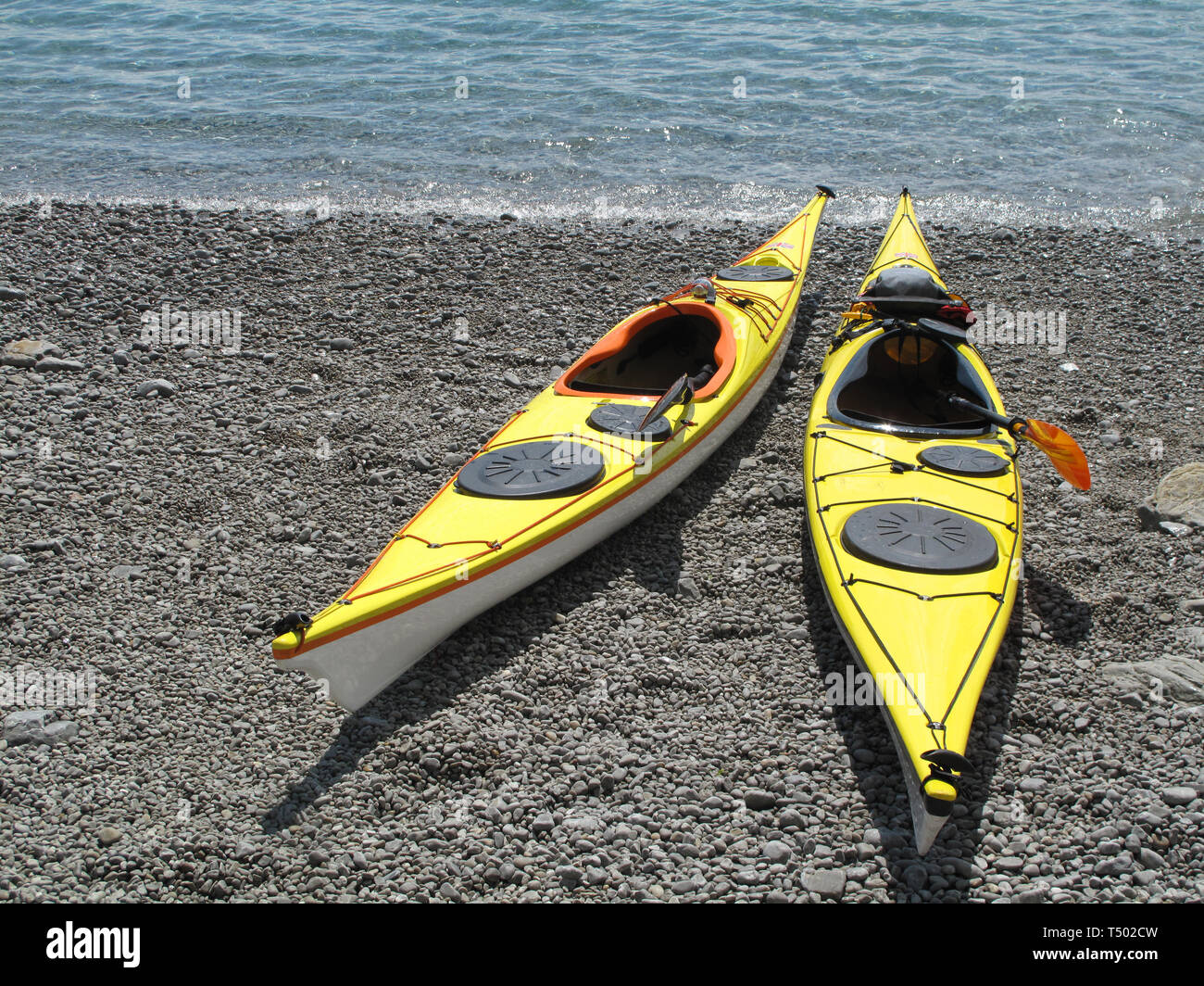 Two kayaks on stony beach Stock Photo - Alamy