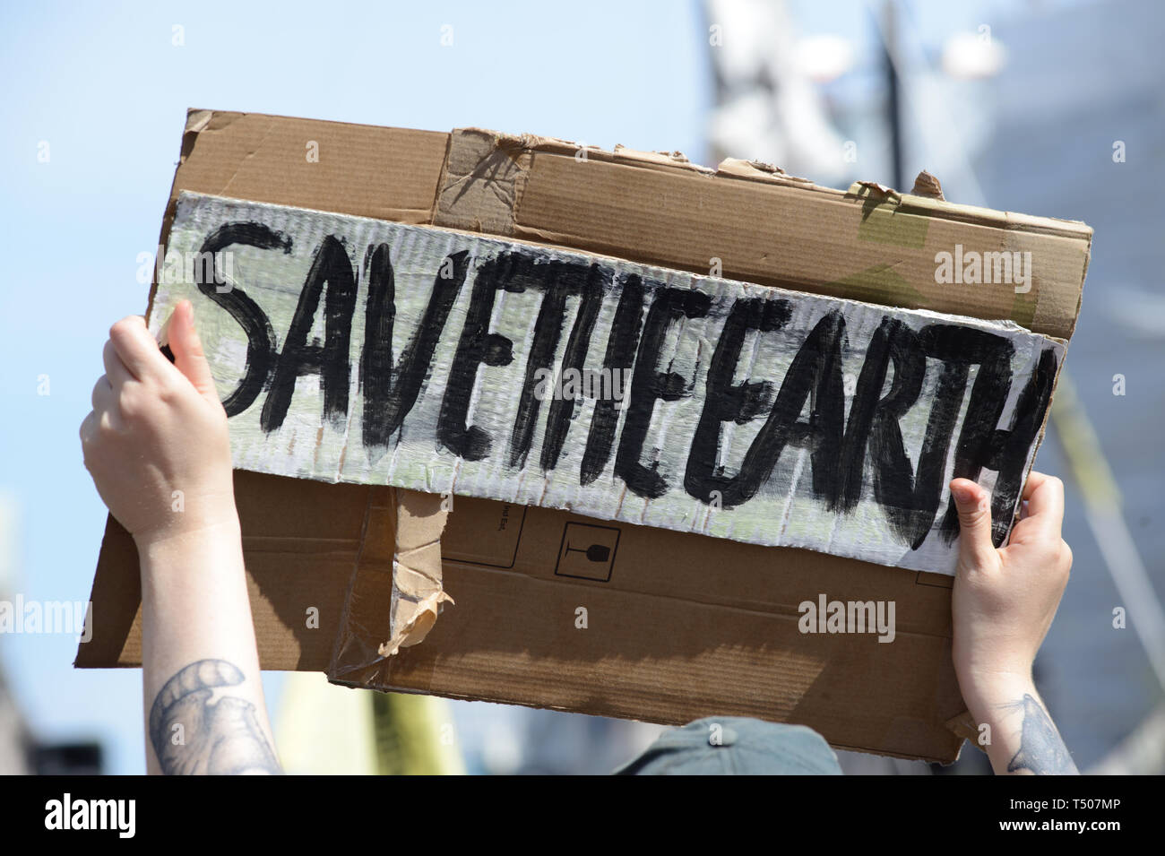 Extinction rebellion protest in London. A sign saying "Save the earth ...