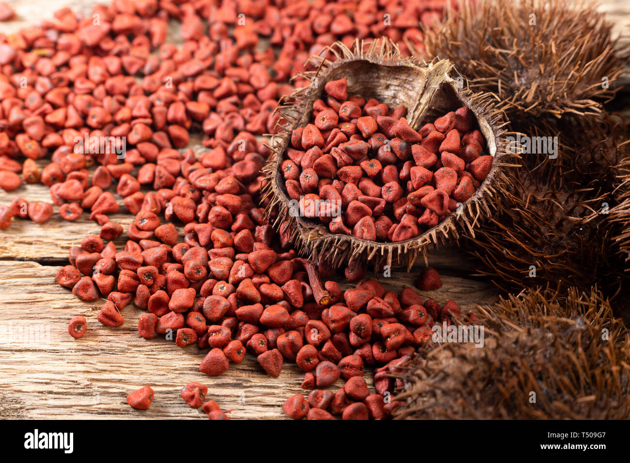 Annatto seeds on rustic wood, top view Stock Photo - Alamy