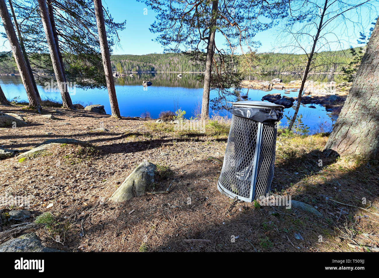 Garbage can near a little lake in Sweden Stock Photo - Alamy