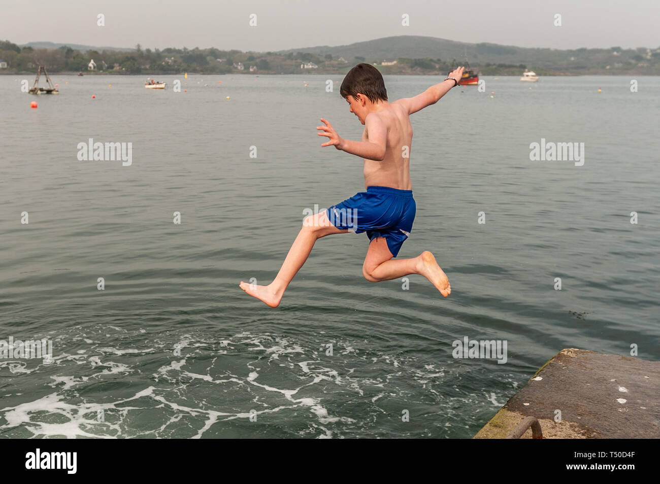 Boy jumping off pier hi-res stock photography and images - Alamy