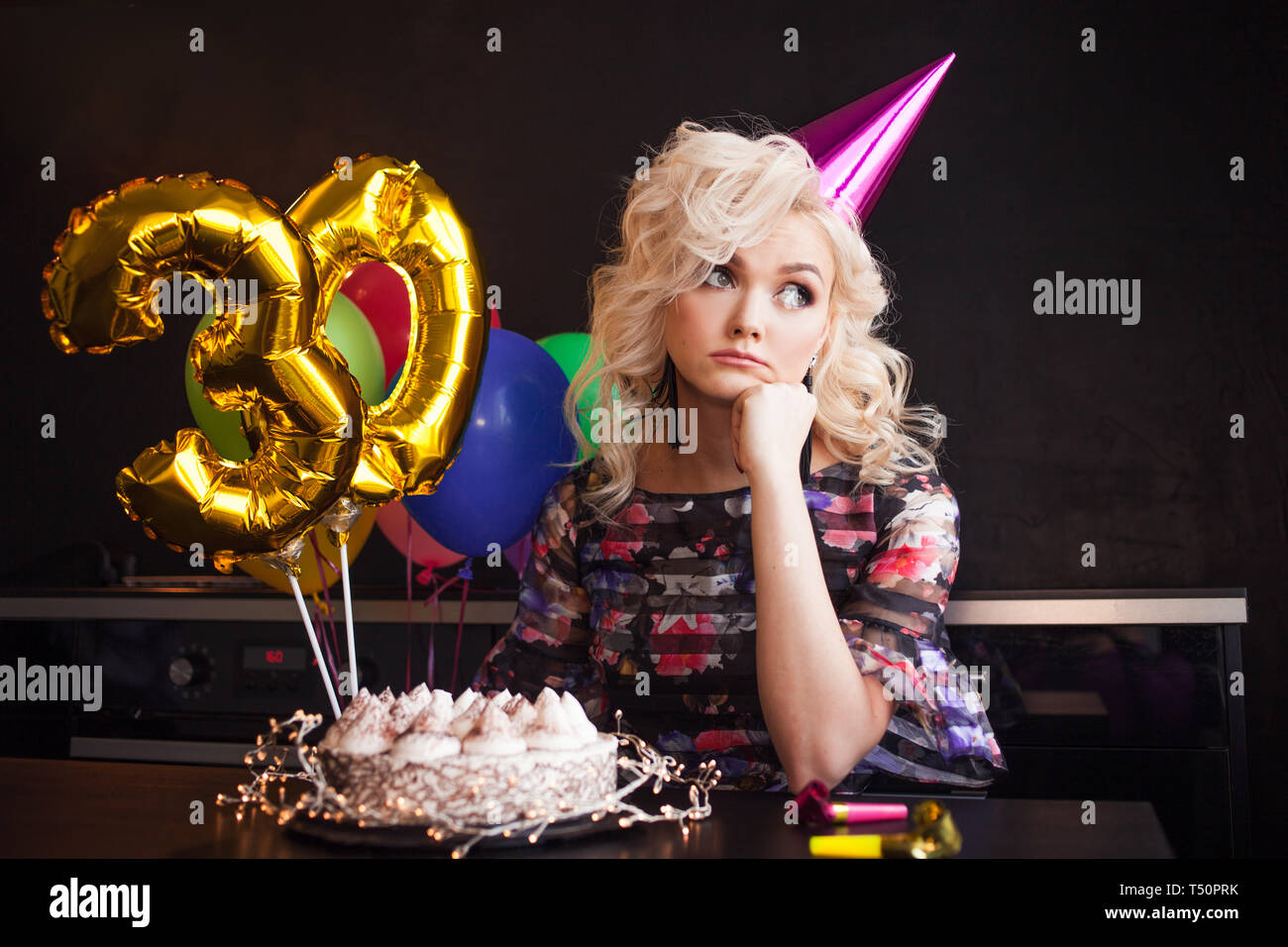 Anniversary Birthday Young Beautiful Blonde Sitting In Front Of A Birthday Cake And Sad