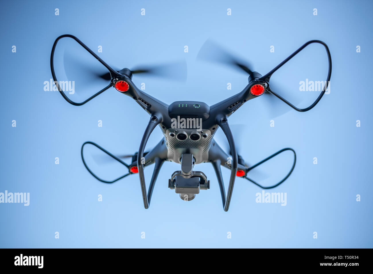 Drone in the sky. Unmanned aerial vehicle flying in the air Stock Photo ...