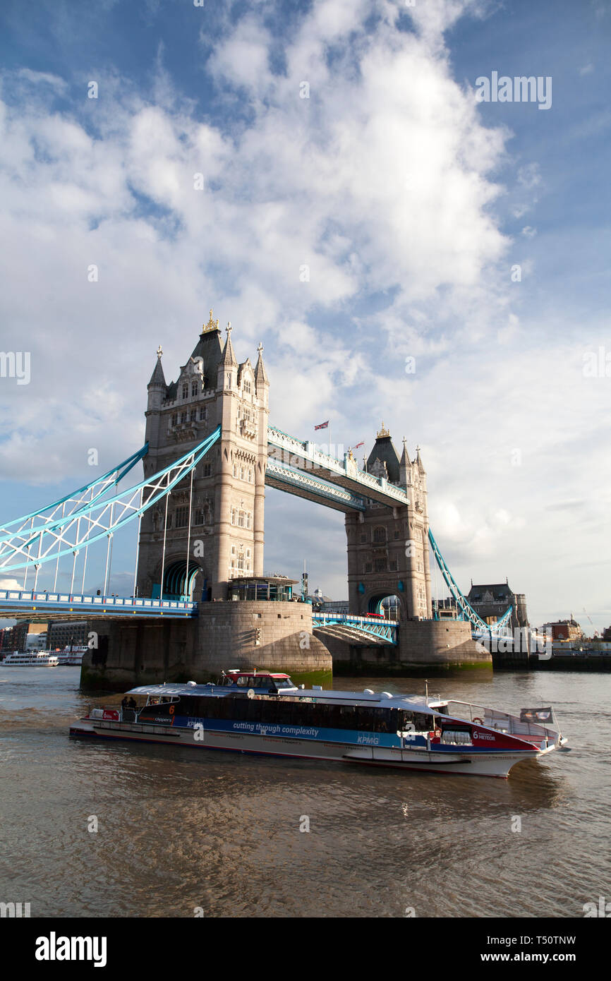 A Thames Clipper passes underneath Tower Bridge, London, UK Stock Photo ...