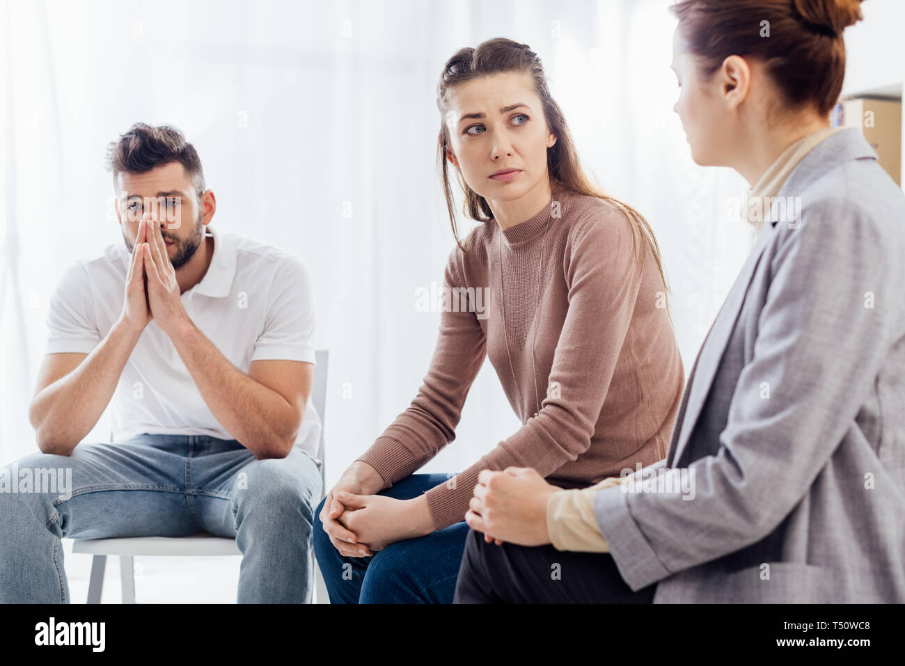 women and man sitting during group therapy session Stock Photo - Alamy