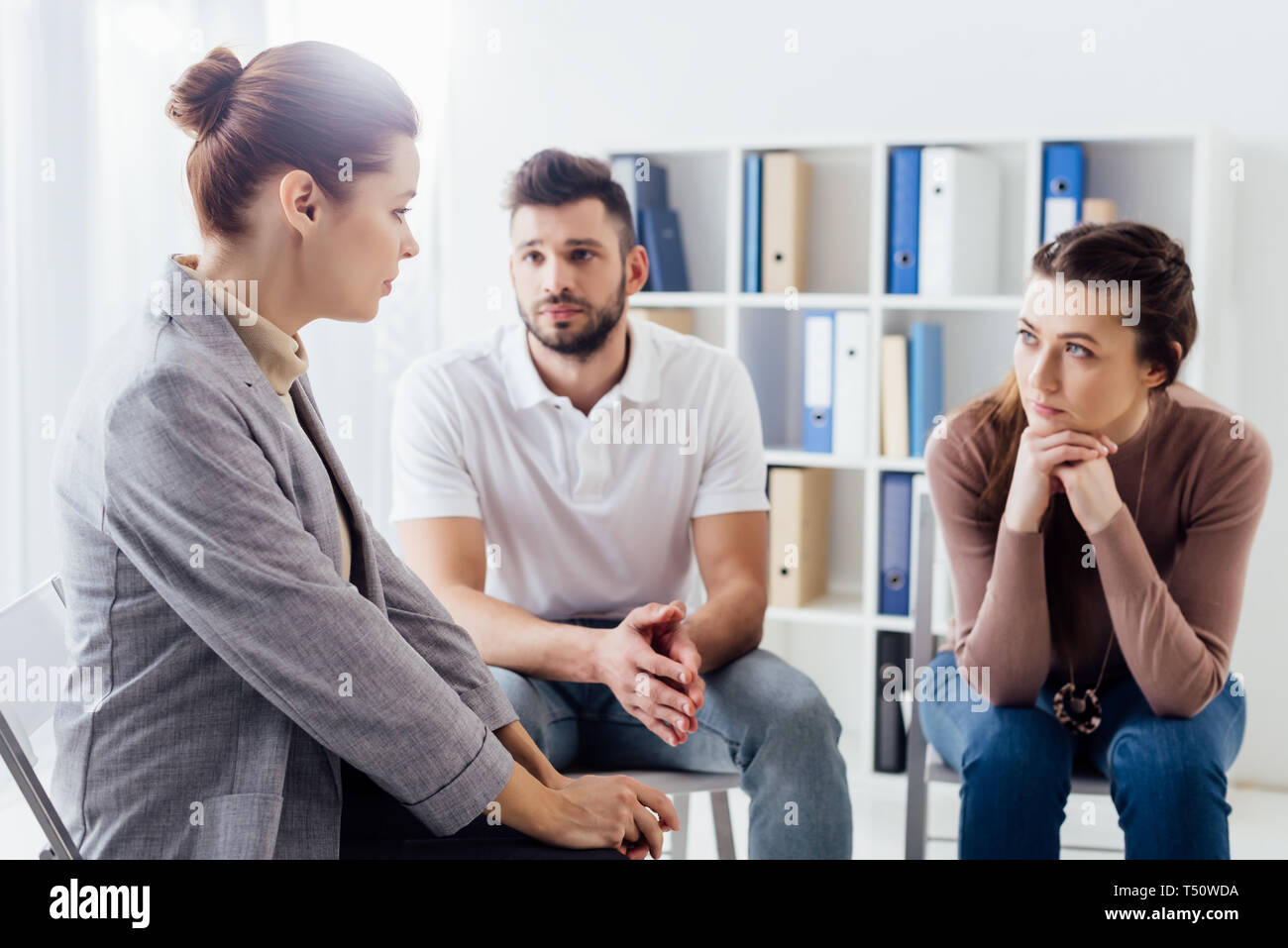 women and man sitting on chairs during group therapy session Stock ...