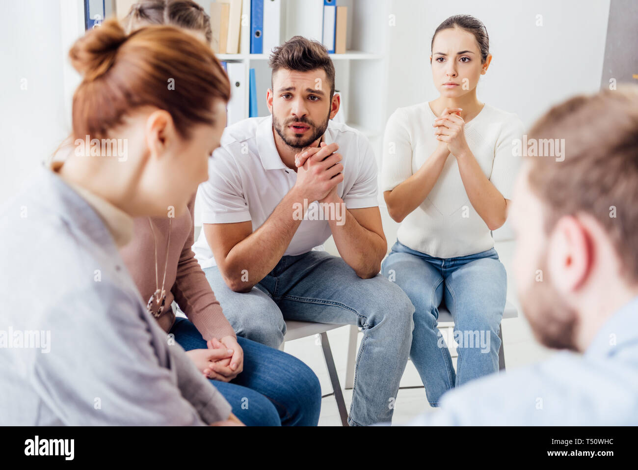 people sitting on chairs and having group therapy meeting Stock Photo ...