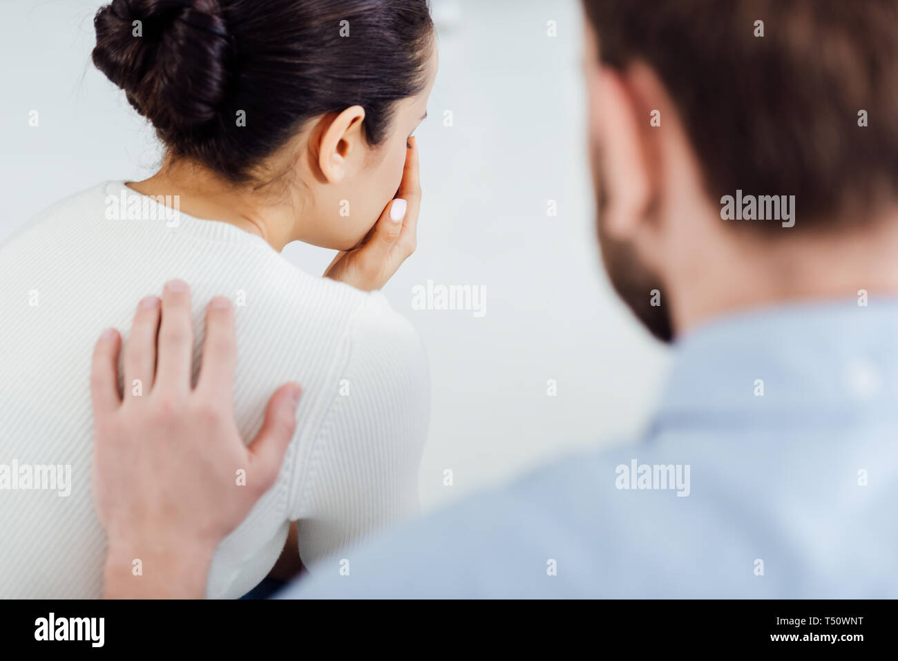 back view of man consoling woman during therapy meeting Stock Photo - Alamy