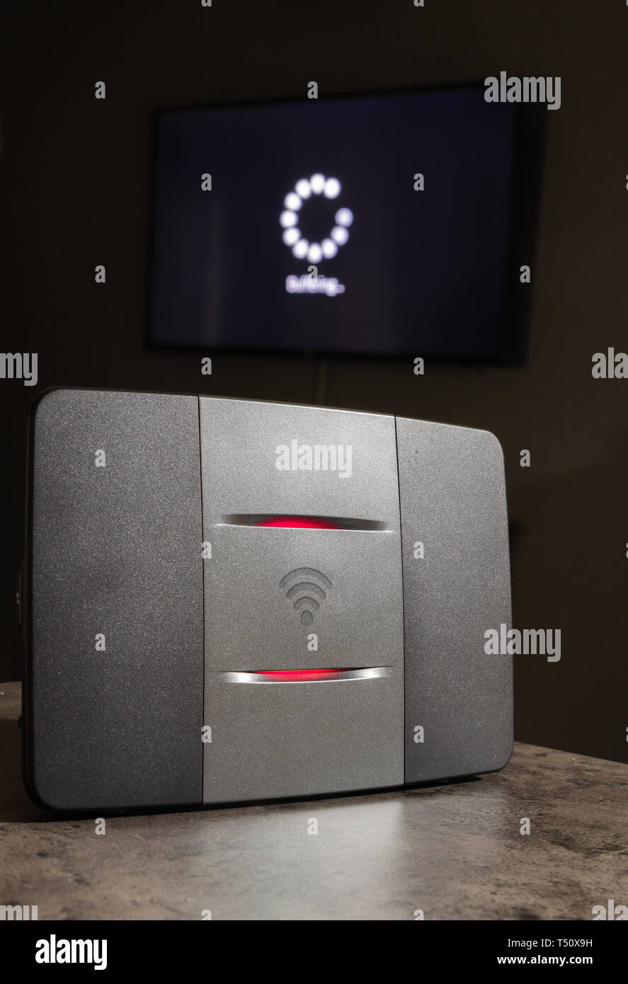 Broadband router with buffering tv in background highlighting poor ...