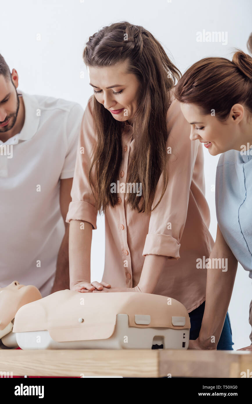 beautiful woman performing chest compression on dummy during cpr ...