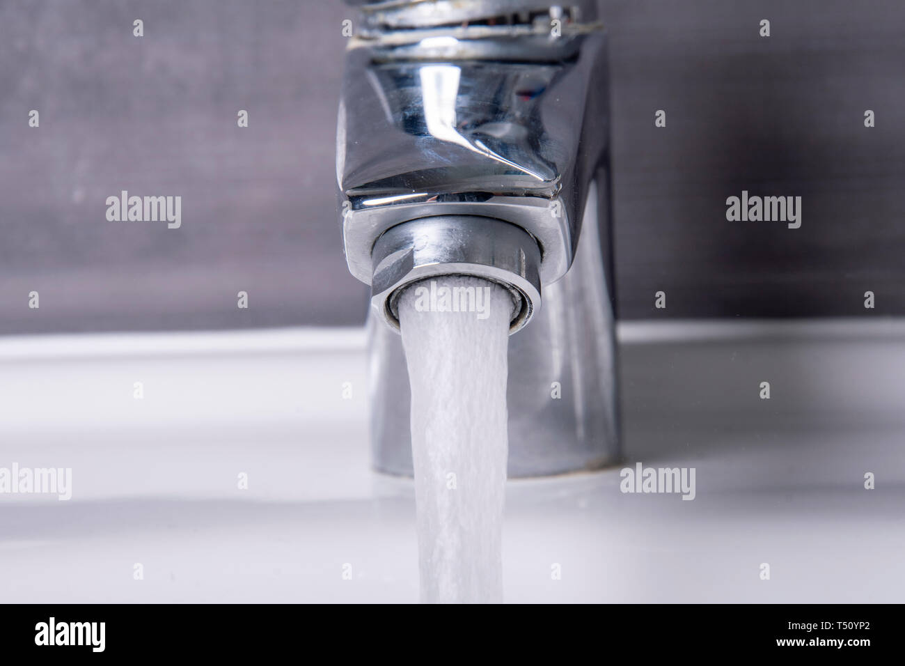 tap with flowing water into the sink Stock Photo - Alamy