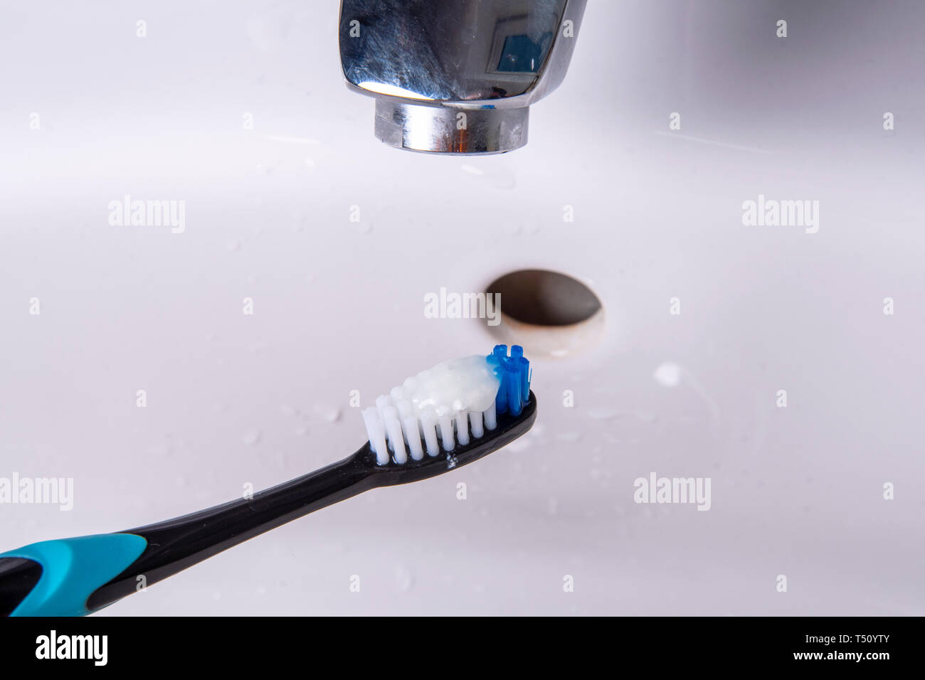Toothbrush under running water hi-res stock photography and images - Alamy