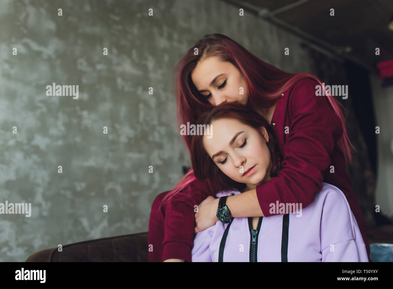 LGBT Cute young girls smiling and flirting on sofa at home Stock Photo ...