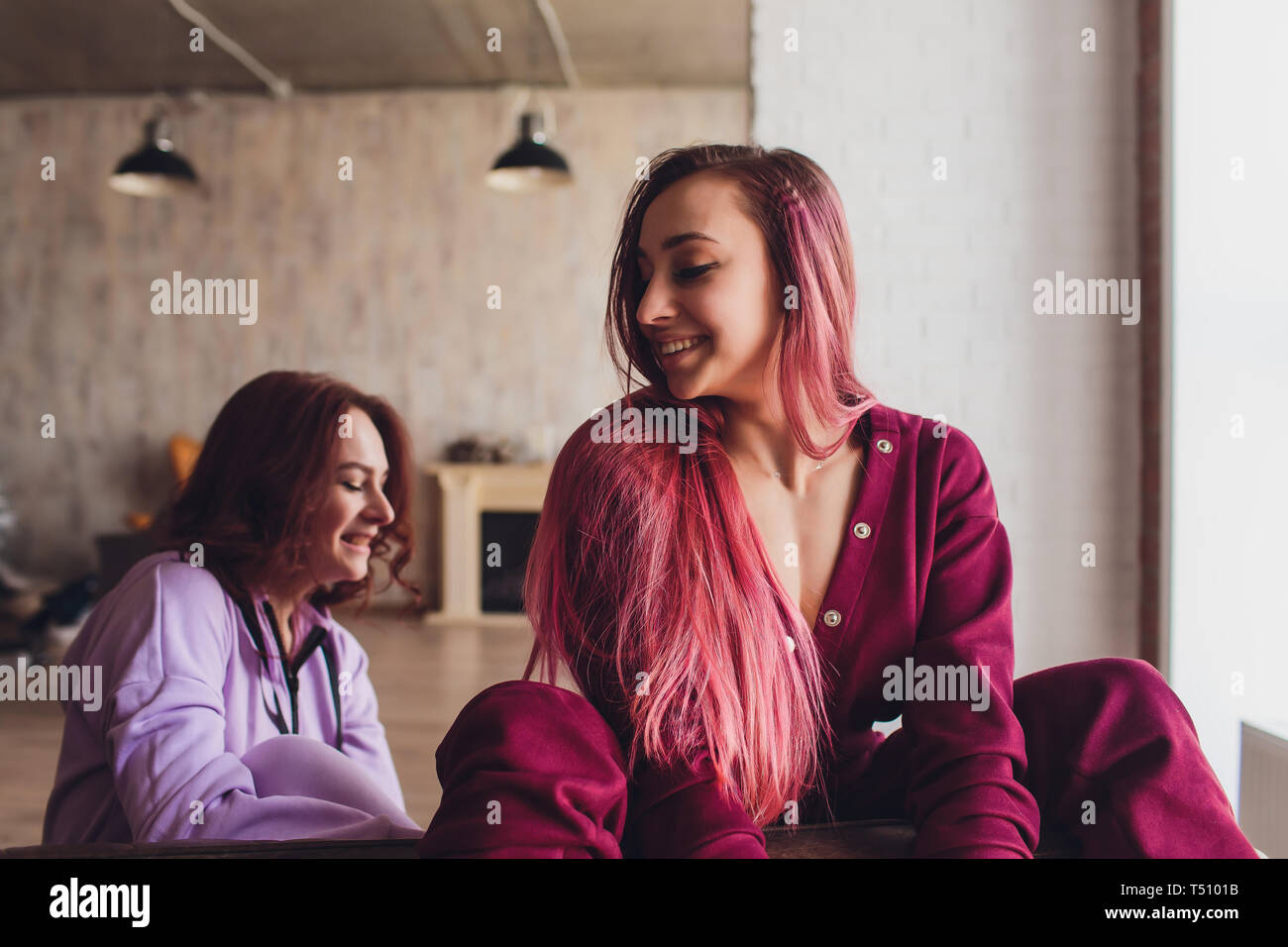 LGBT Cute young girls smiling and flirting on sofa at home Stock Photo ...