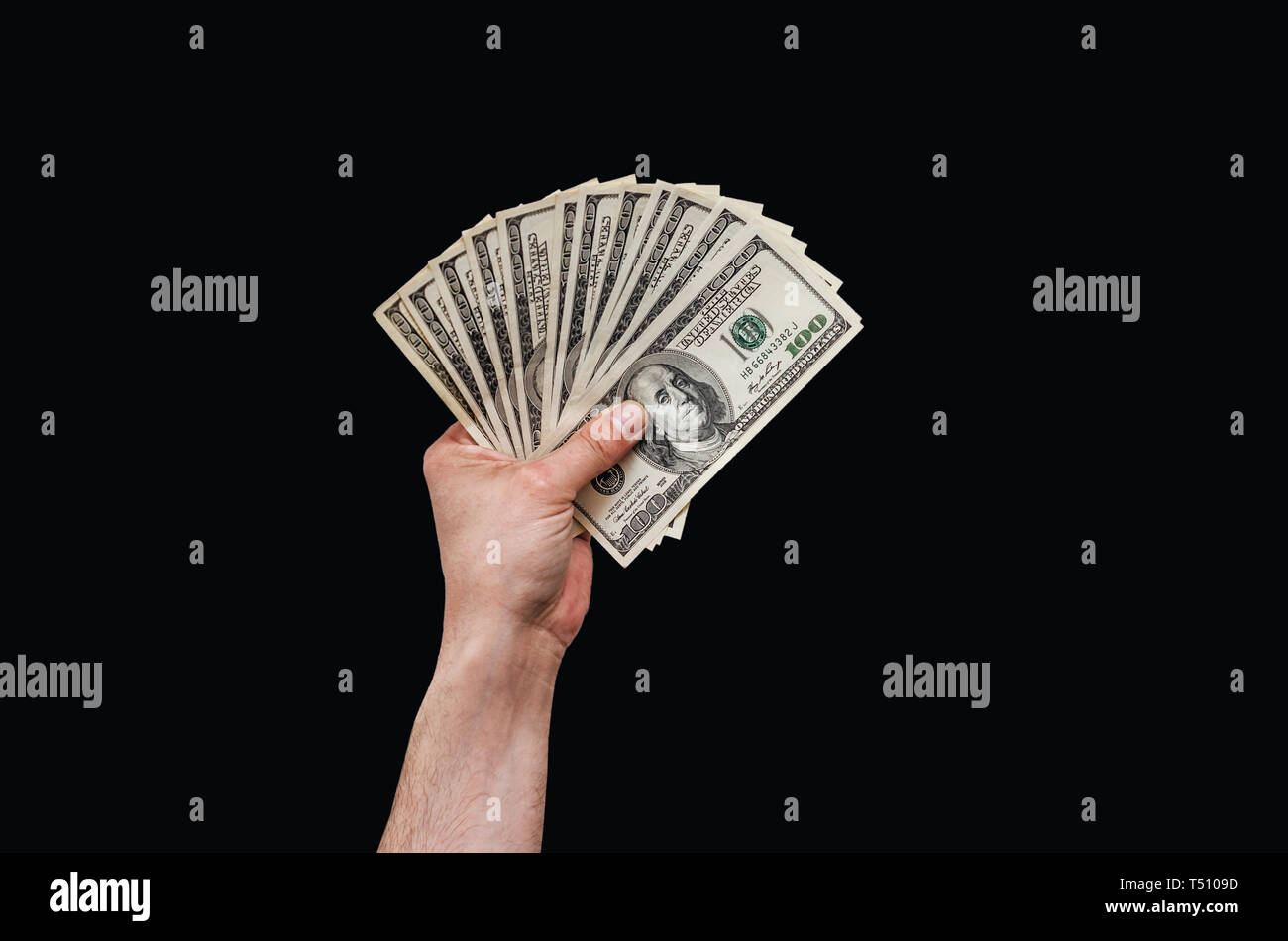 Man's hand holds american dollars money. On black background. Finance ...