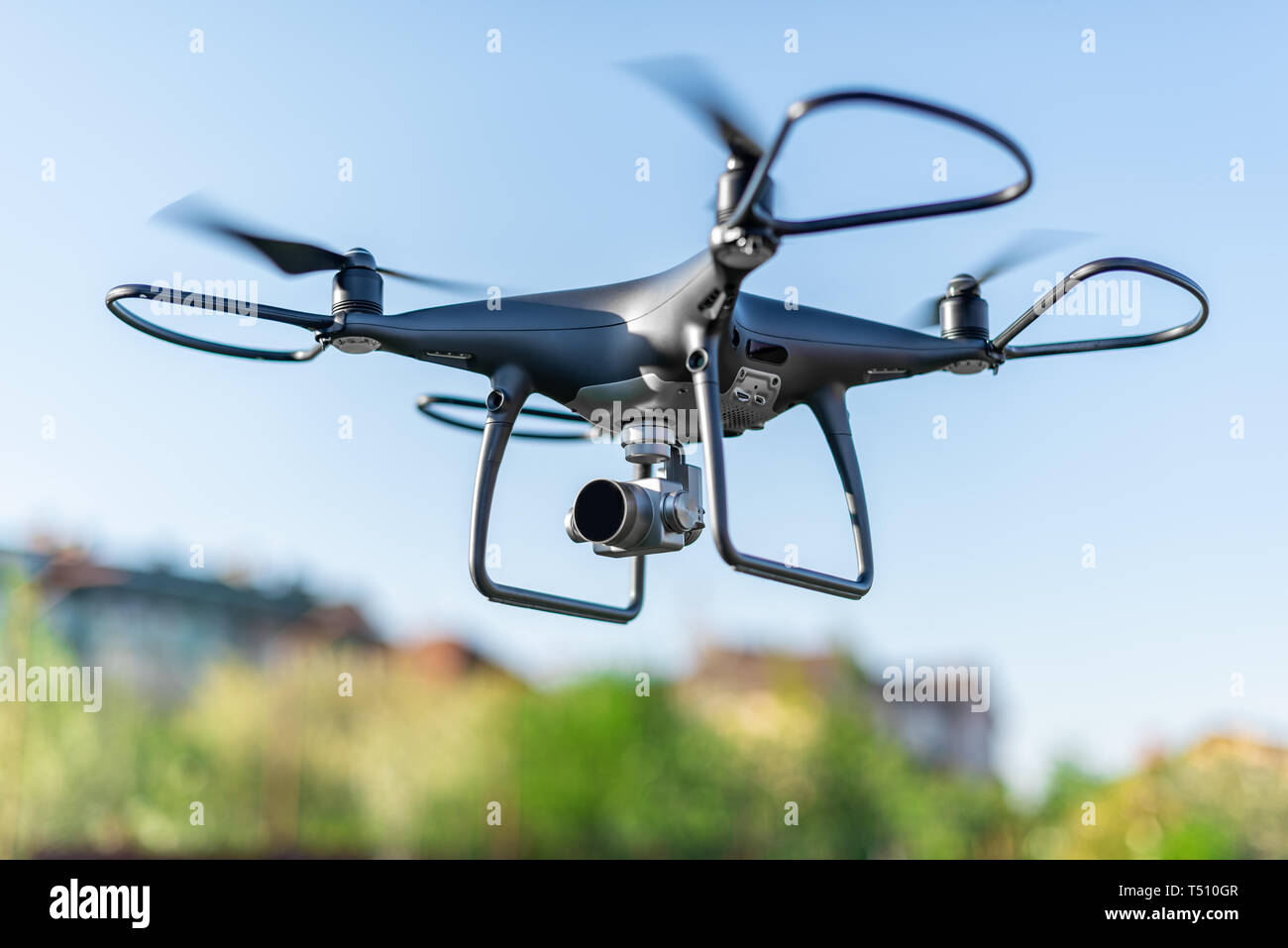Dark drone flying through the air in the sun Stock Photo - Alamy