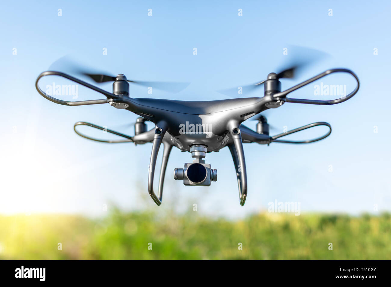 Dark drone flying through the air in the sun Stock Photo - Alamy