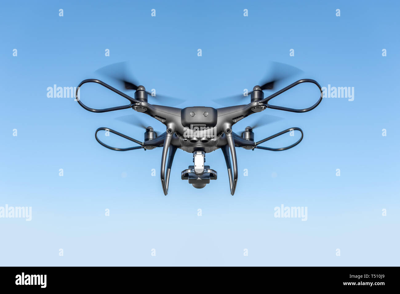 Dark drone flying through the air in the sun Stock Photo - Alamy