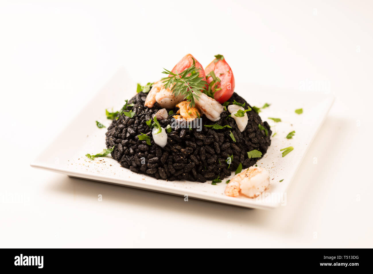 Black rice with cuttlefish on white background close up Stock Photo - Alamy