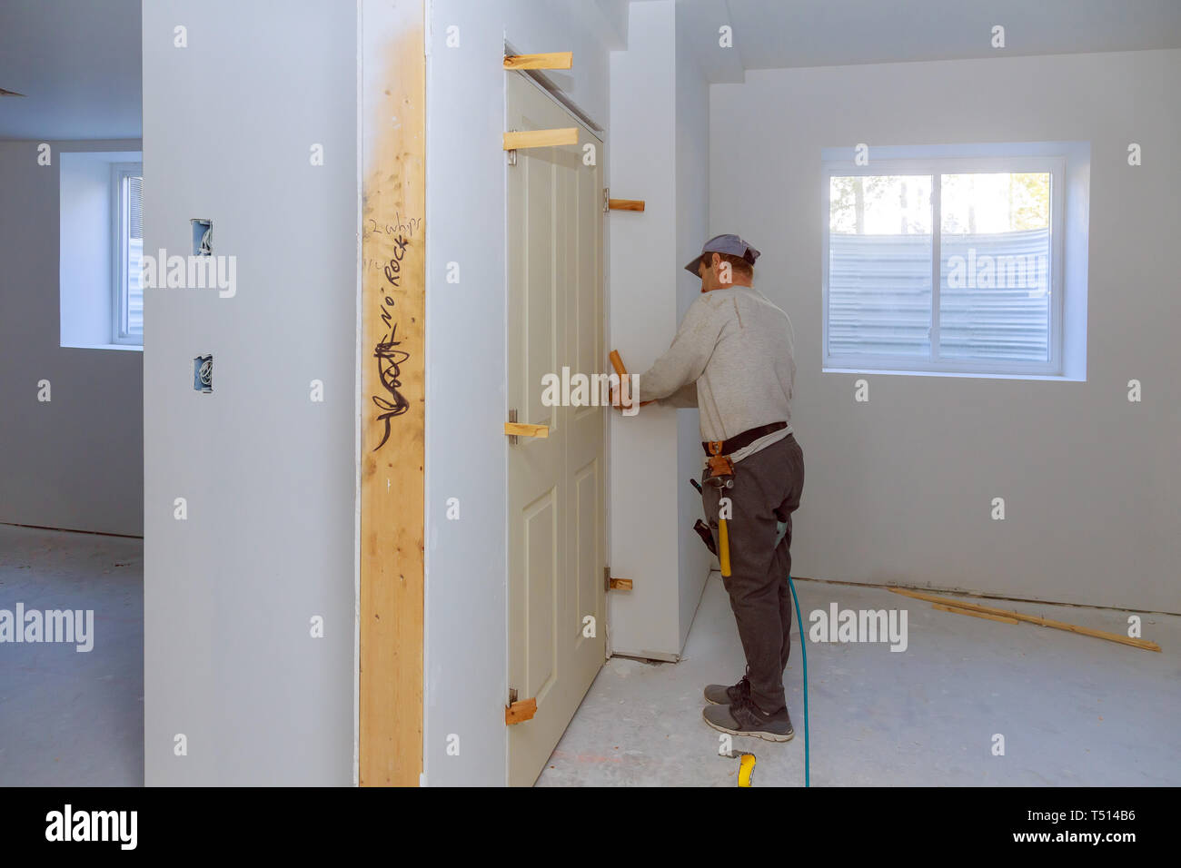 Handyman install the new twin door for interior in the room Stock Photo ...