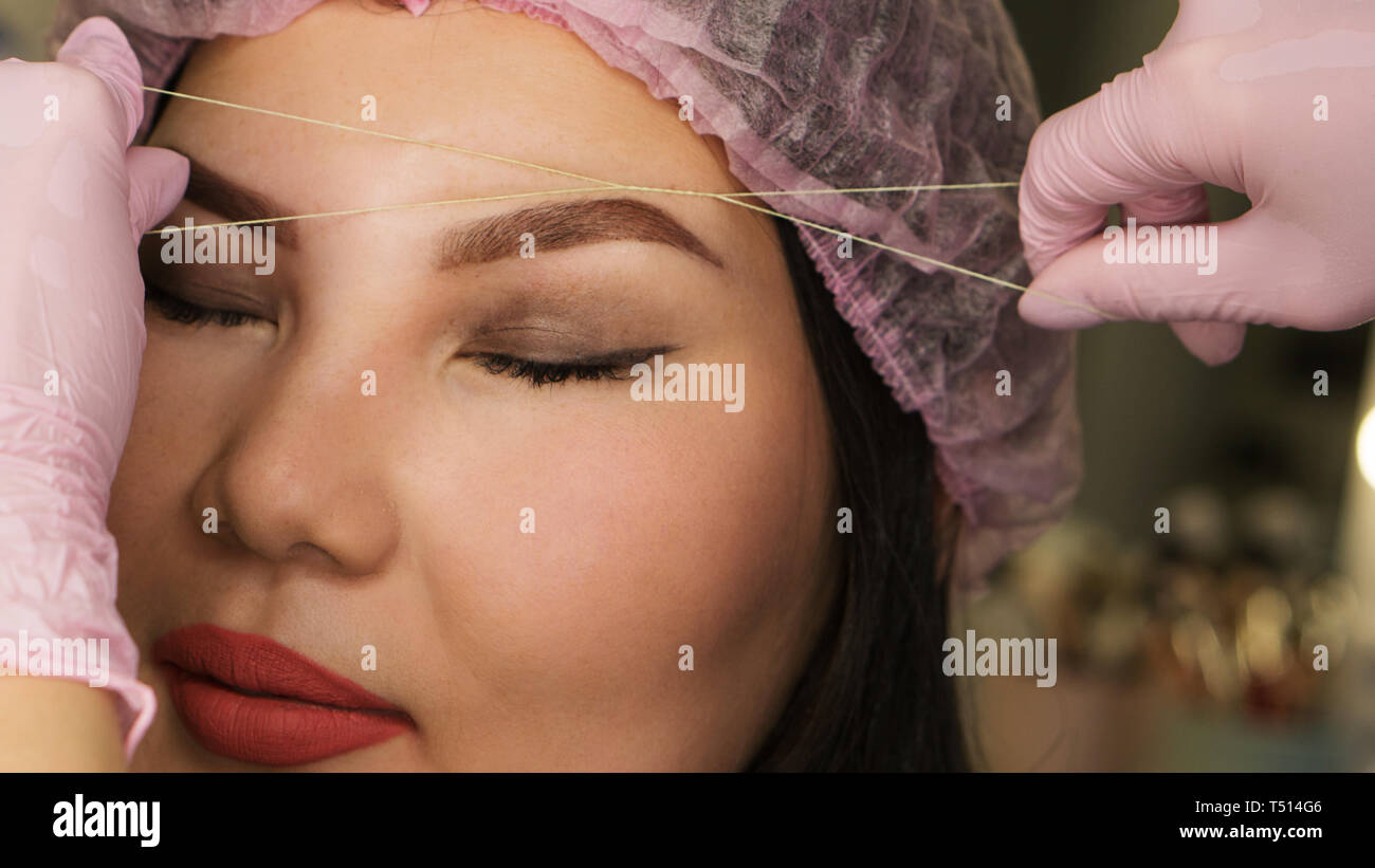 Microbleeding and eyebrow architecture. Beautician checks correctness ...
