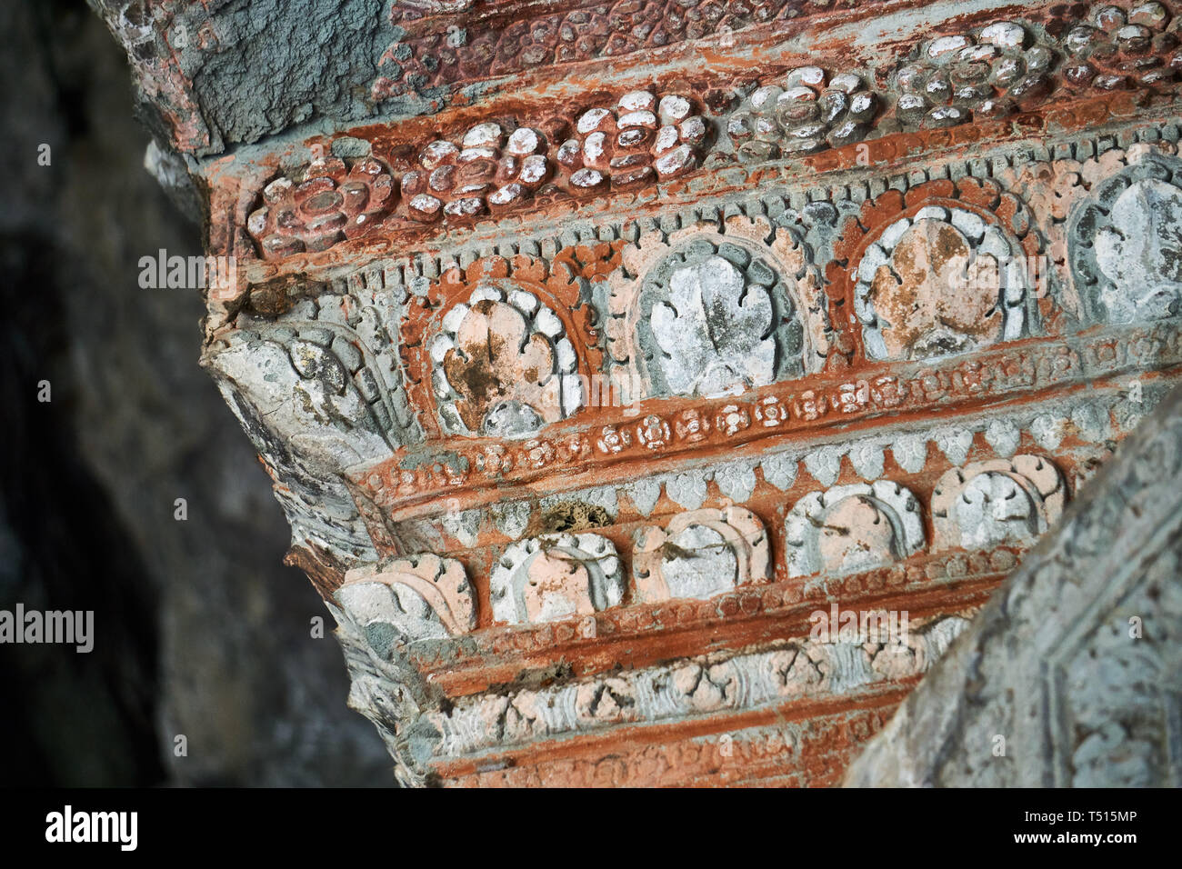 Rust-red and gray (grey) circular patterns (medallions) engraved in the ...