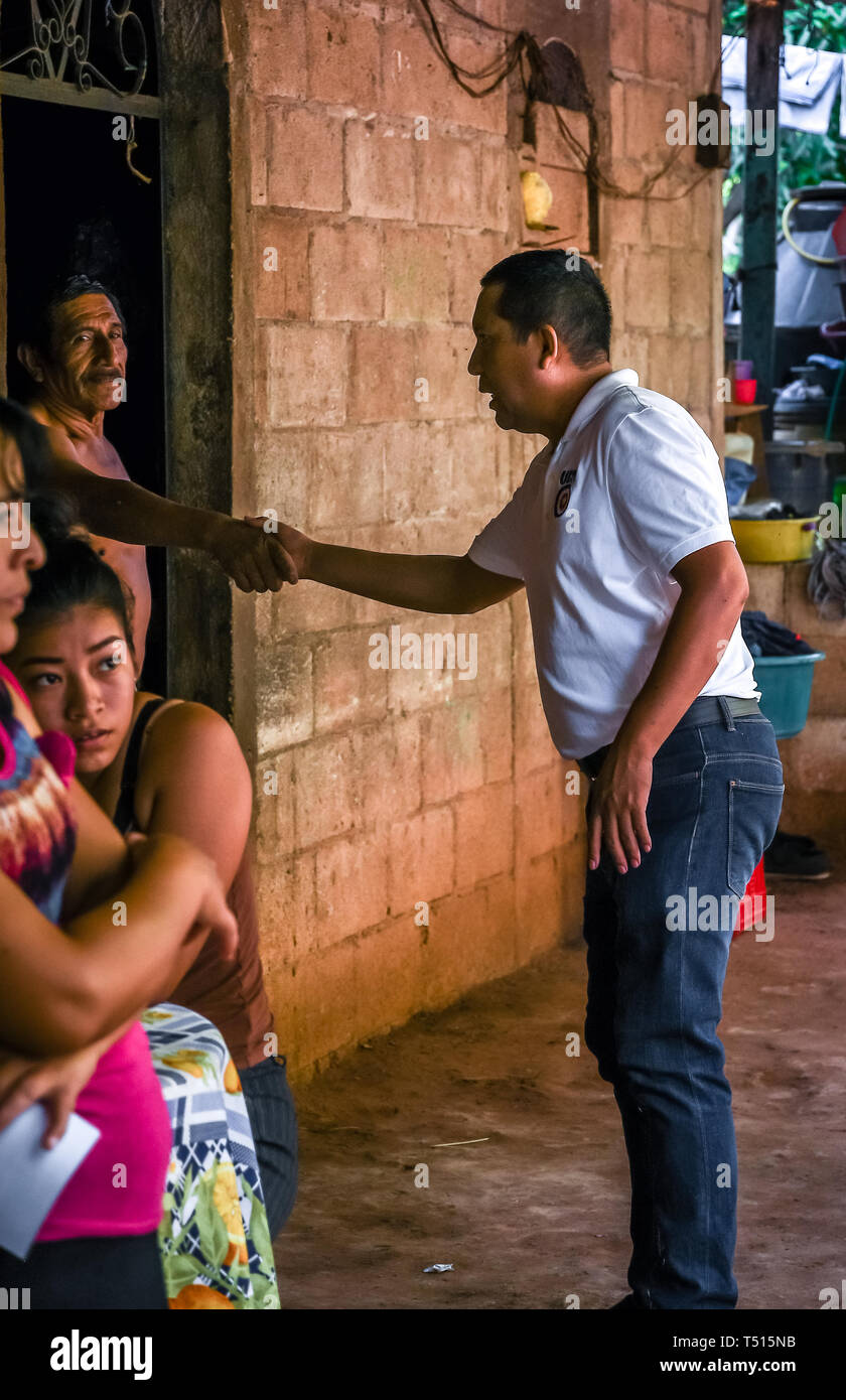 latin people shaking hands in Guatemalan village Stock Photo - Alamy