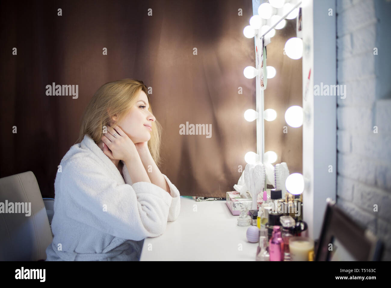Amazing young woman brush her hair in front of mirror. Portrait of ...