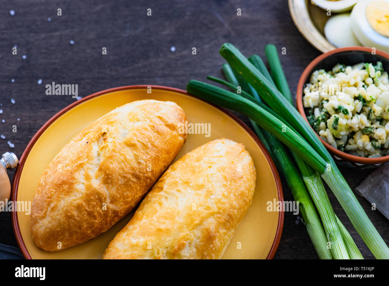 Traditional georgian pies with eggs, rice and green onion on dark ...