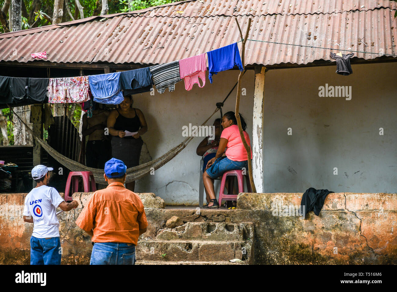 people speaking outside house in poor Guatemalan village Stock Photo ...