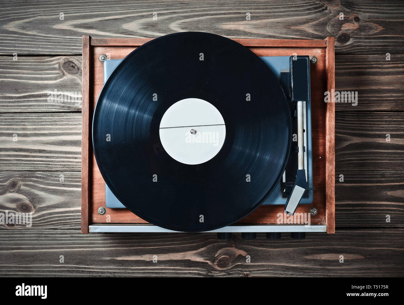 Vinyl player with plates on a wooden table. Entertainment 70s. Listen ...