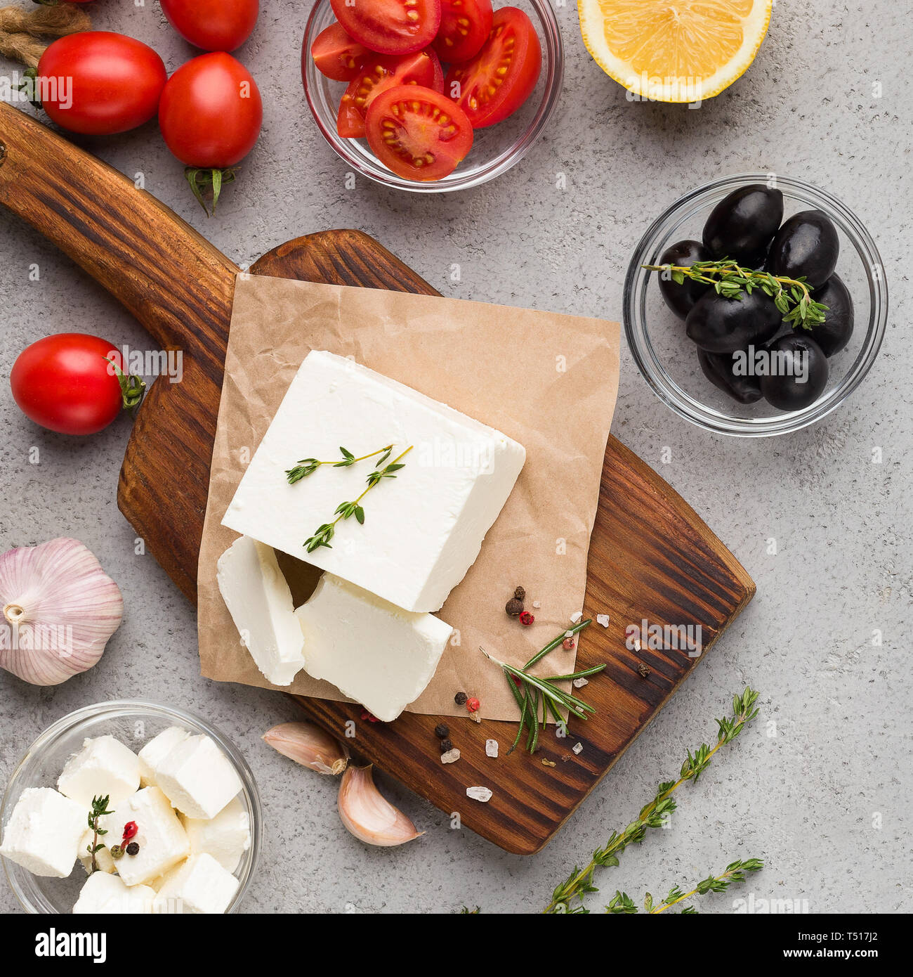 Block of feta cheese and vegetables on concrete background Stock Photo ...