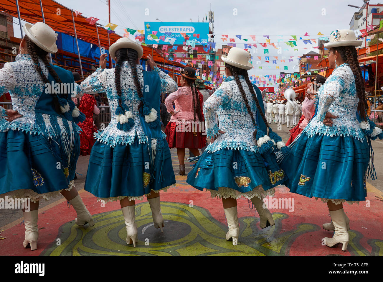 Morenada dancers in ornate costumes parading through the mining city of ...