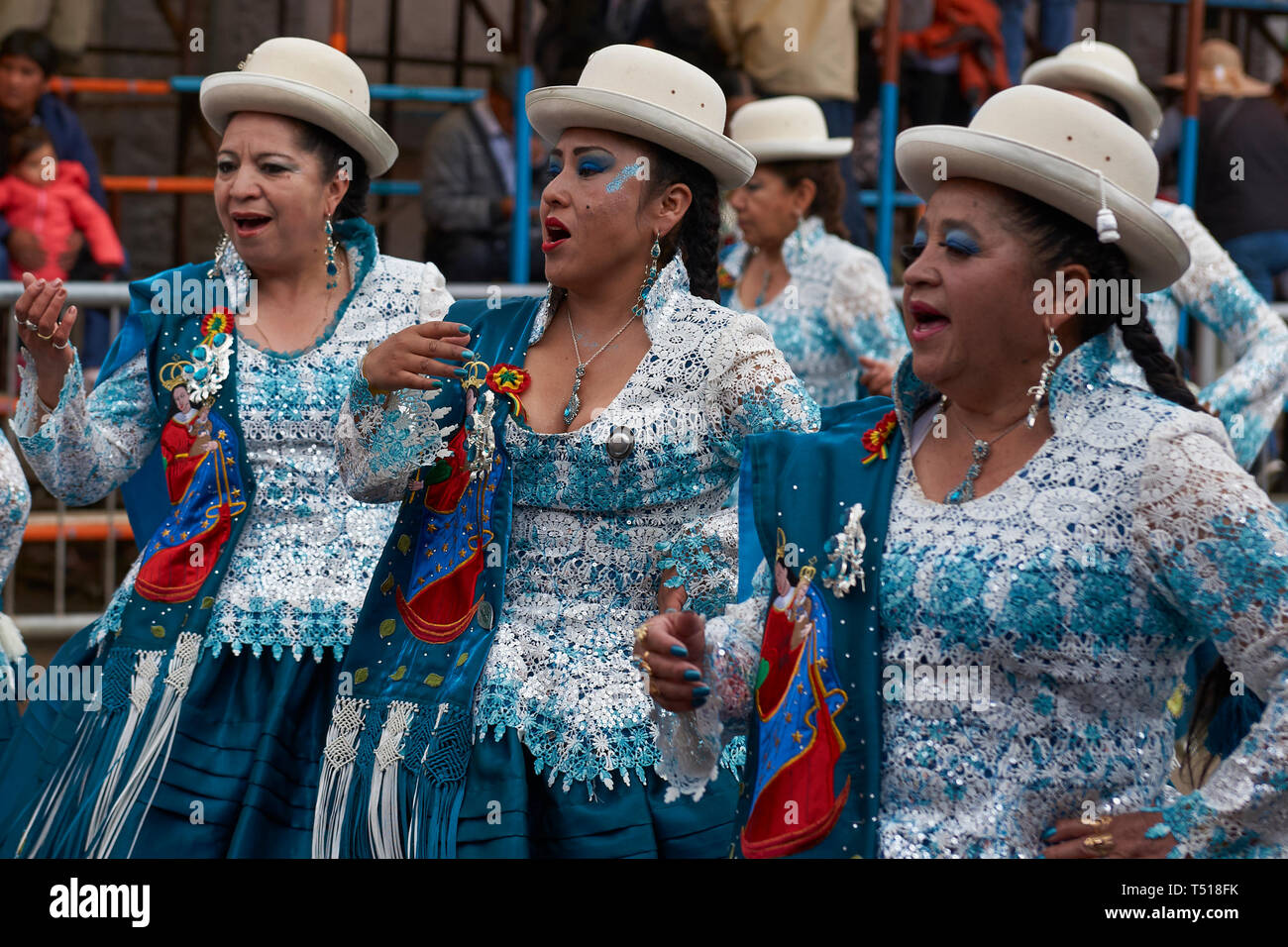 Morenada dancers in ornate costumes parading through the mining city of ...