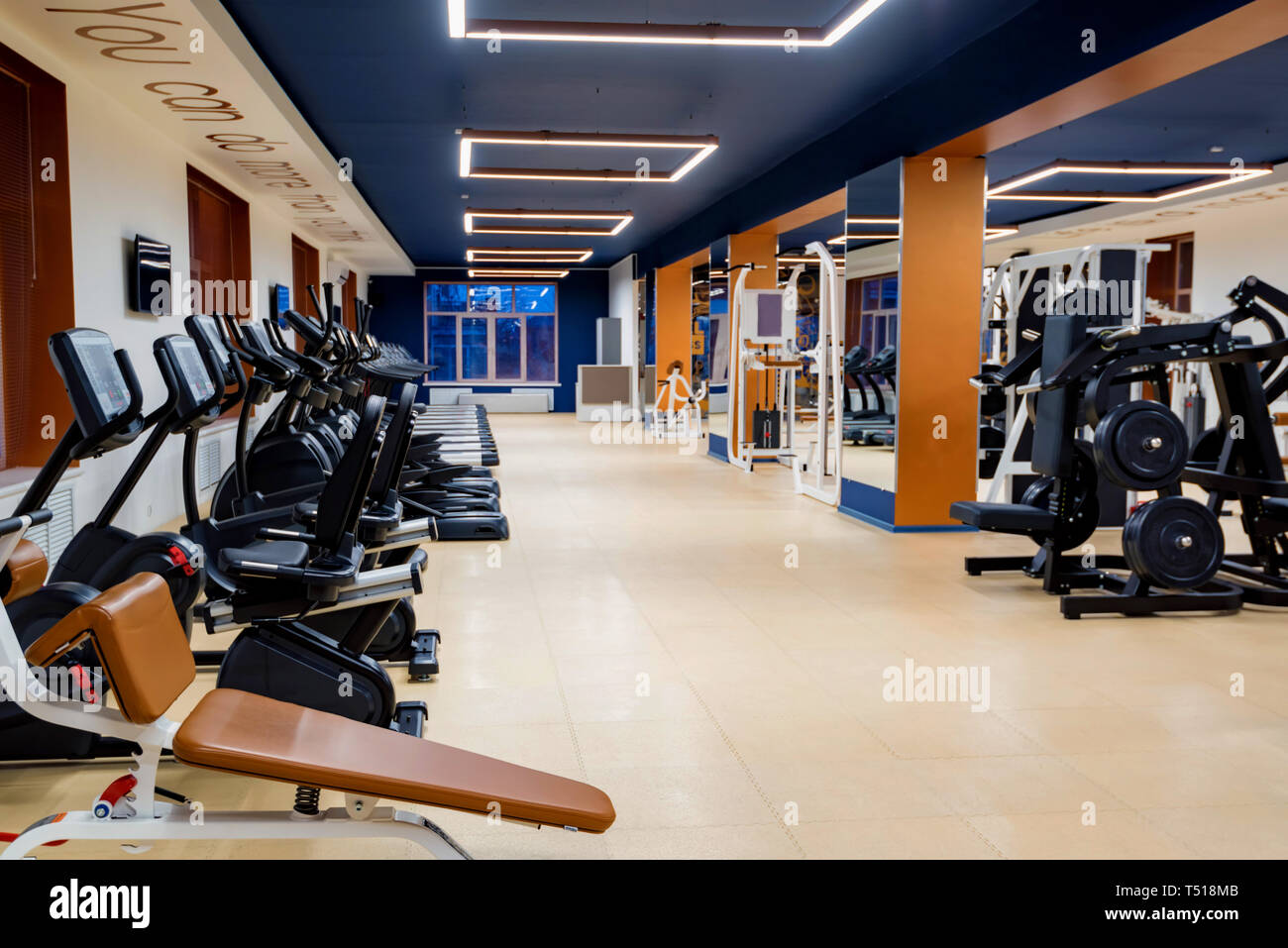 New fitness machines in modern gym interior Stock Photo - Alamy