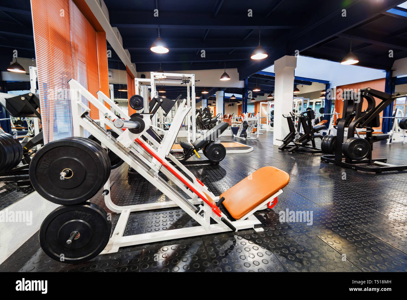 New fitness machines in modern gym interior Stock Photo - Alamy