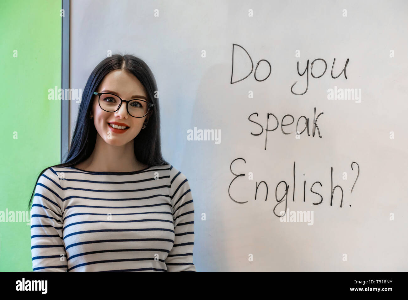 Portrait of beautiful girl with glasses and words do you speak English ...