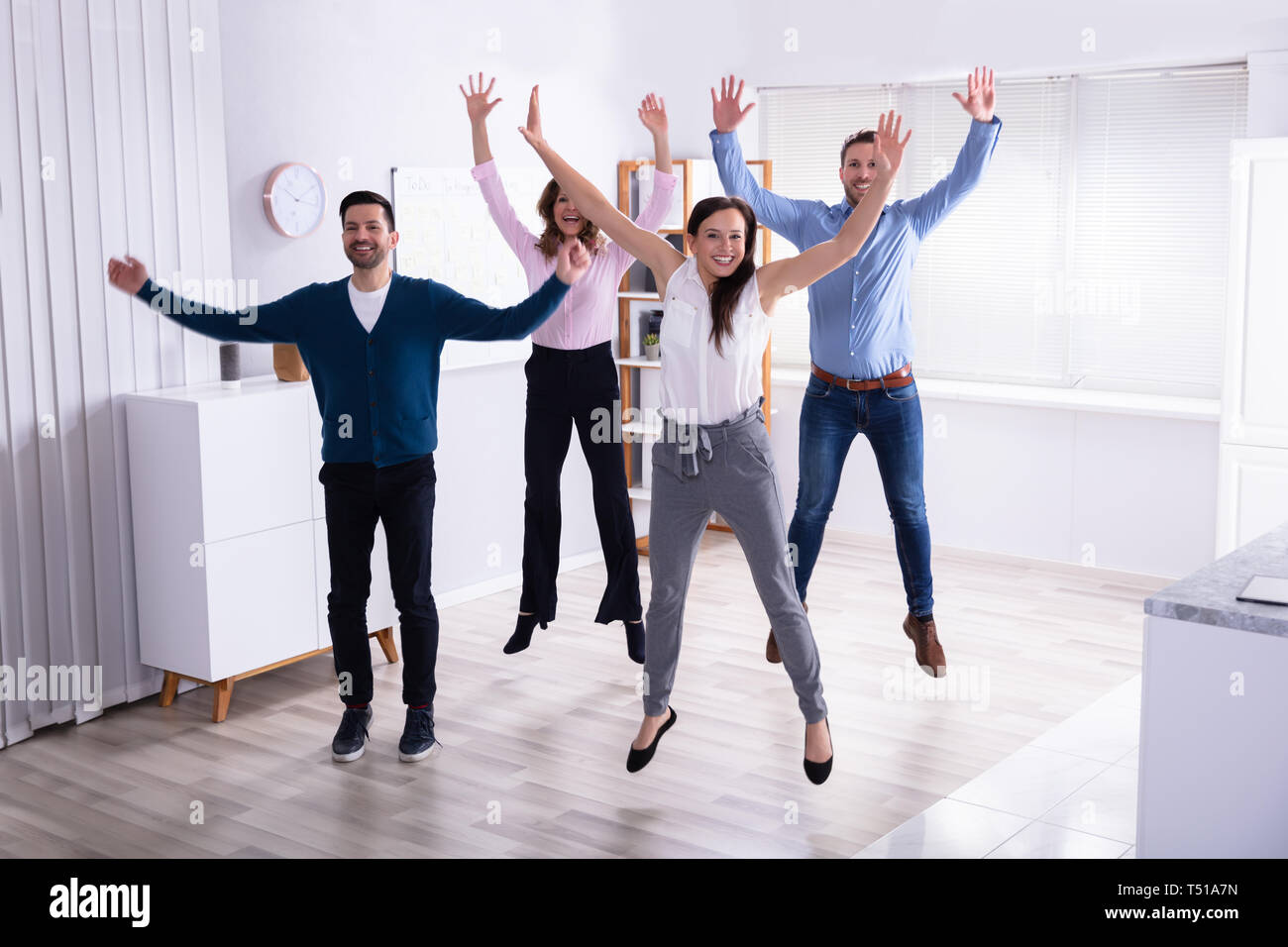 Woman jumping for joy office hi-res stock photography and images - Alamy