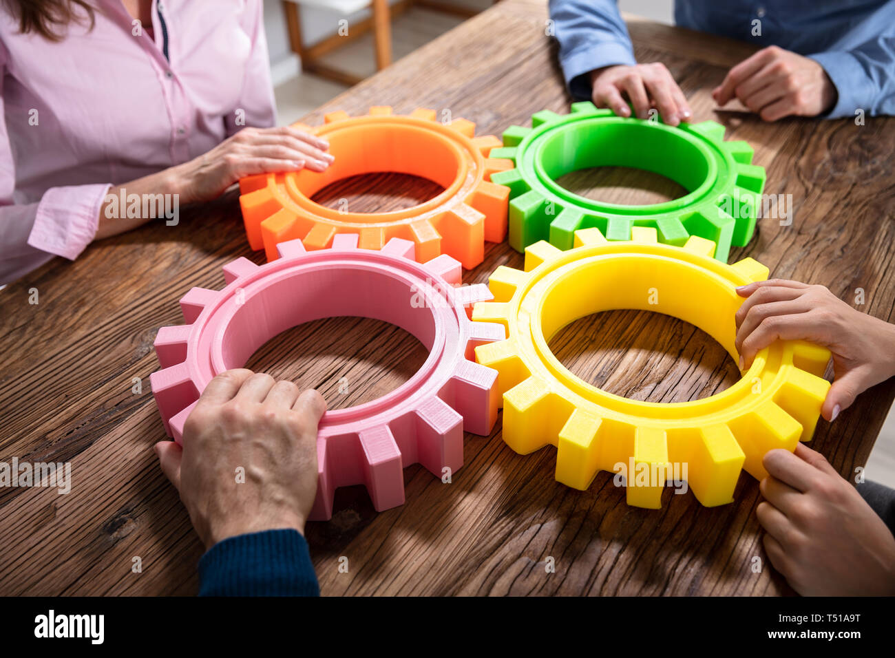 Businessman joining together gears hi-res stock photography and images ...