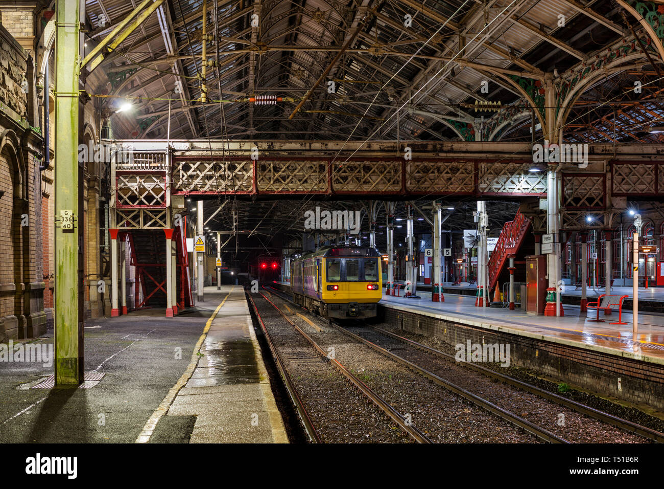 A Arriva Northern rail class 142 pacer train at Preston railway station late at night waiting to ...