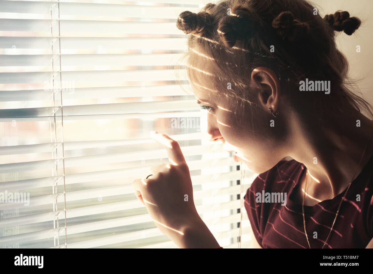 Sad look through blinds hi-res stock photography and images - Alamy