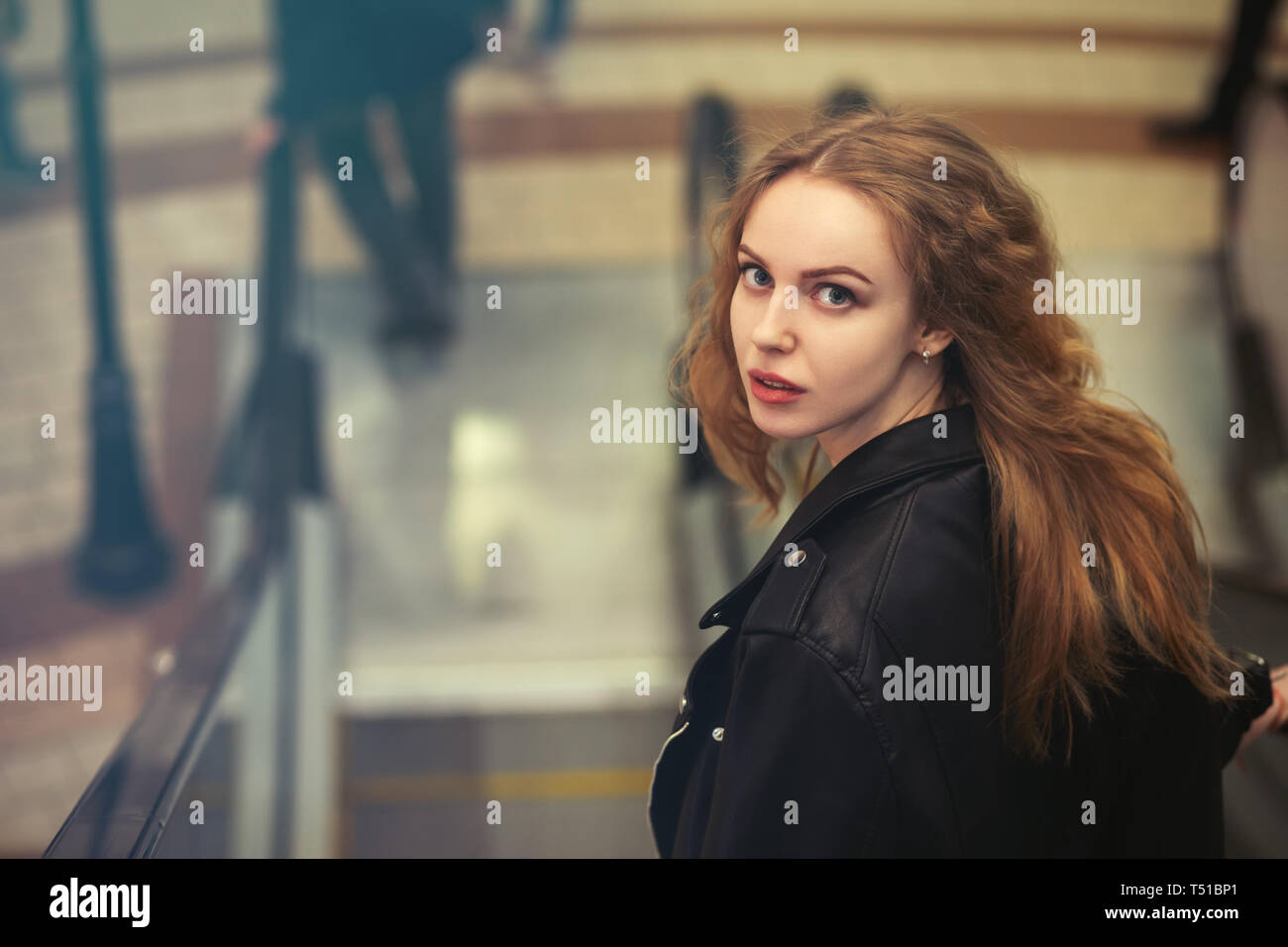scared beautiful blond curly young woman looking back, standing on ...