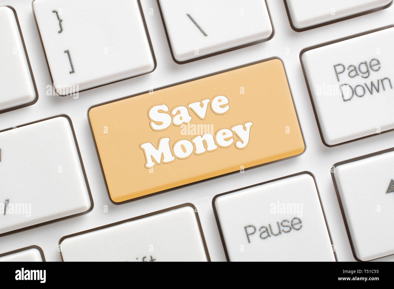 Brown saving money key on keyboard Stock Photo - Alamy