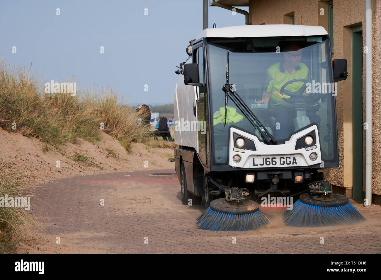 Man sweeping beach hi-res stock photography and images - Alamy