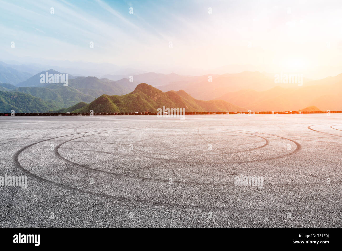 Asphalt race track ground and mountain with sunset clouds Stock Photo ...