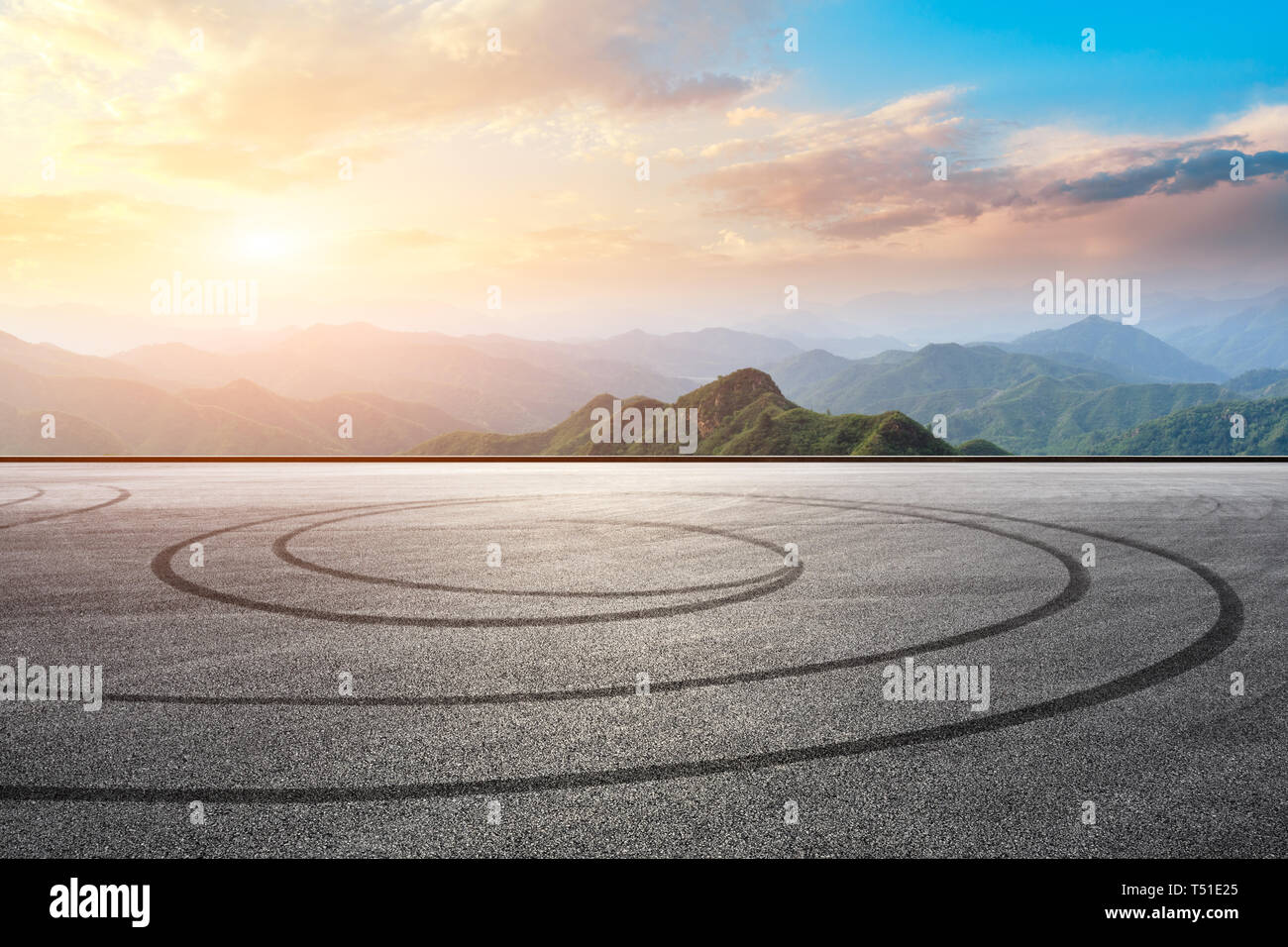 Asphalt race track ground and mountain with sunset clouds Stock Photo ...