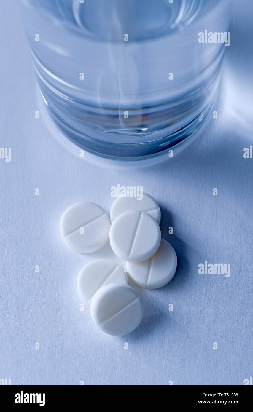 Medicine tablets and glass of water Stock Photo - Alamy