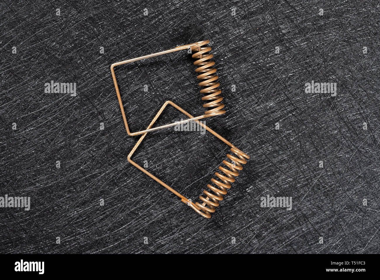 top view two pieces rusty springs on dark background Stock Photo - Alamy